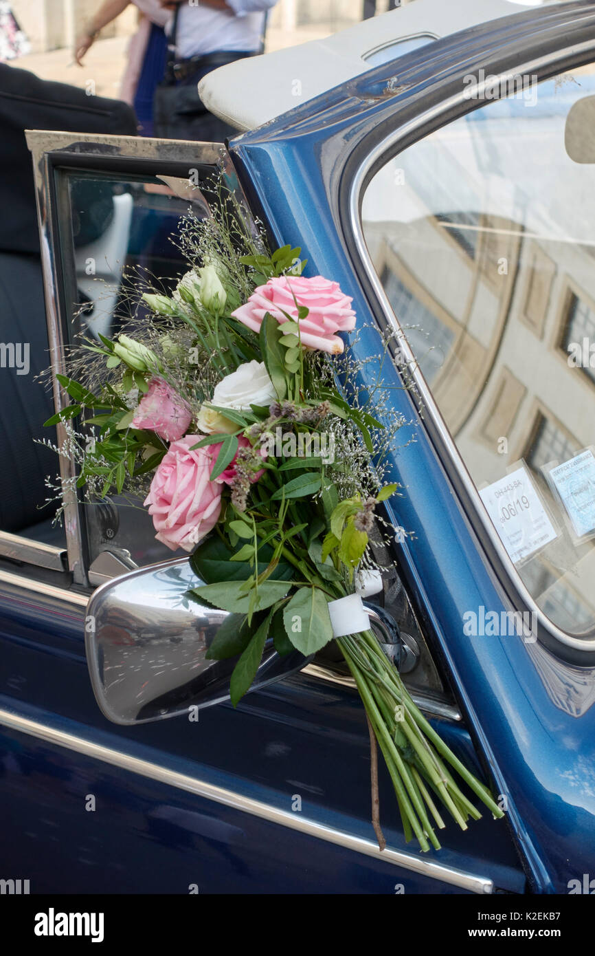 Old Volkswagen Beatle car decorated with bouquet of flowers for a ...
