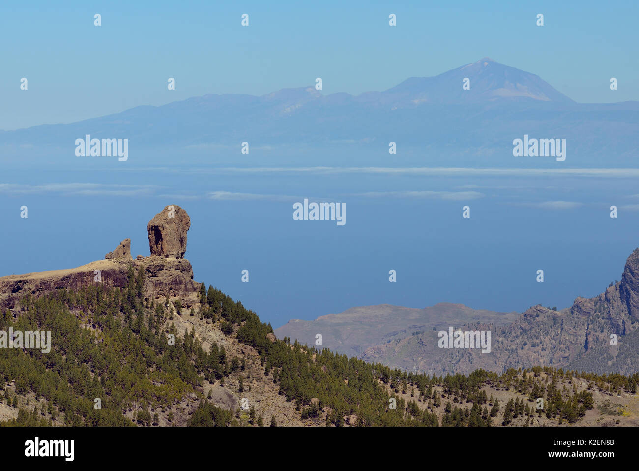 Roque Nublo, a 90m tall volcanic monolith, with El Teide volcano on ...