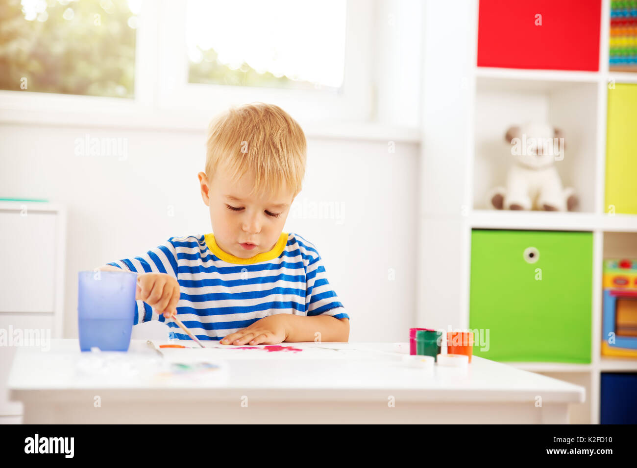 Little child drawing on the paper Stock Photo - Alamy