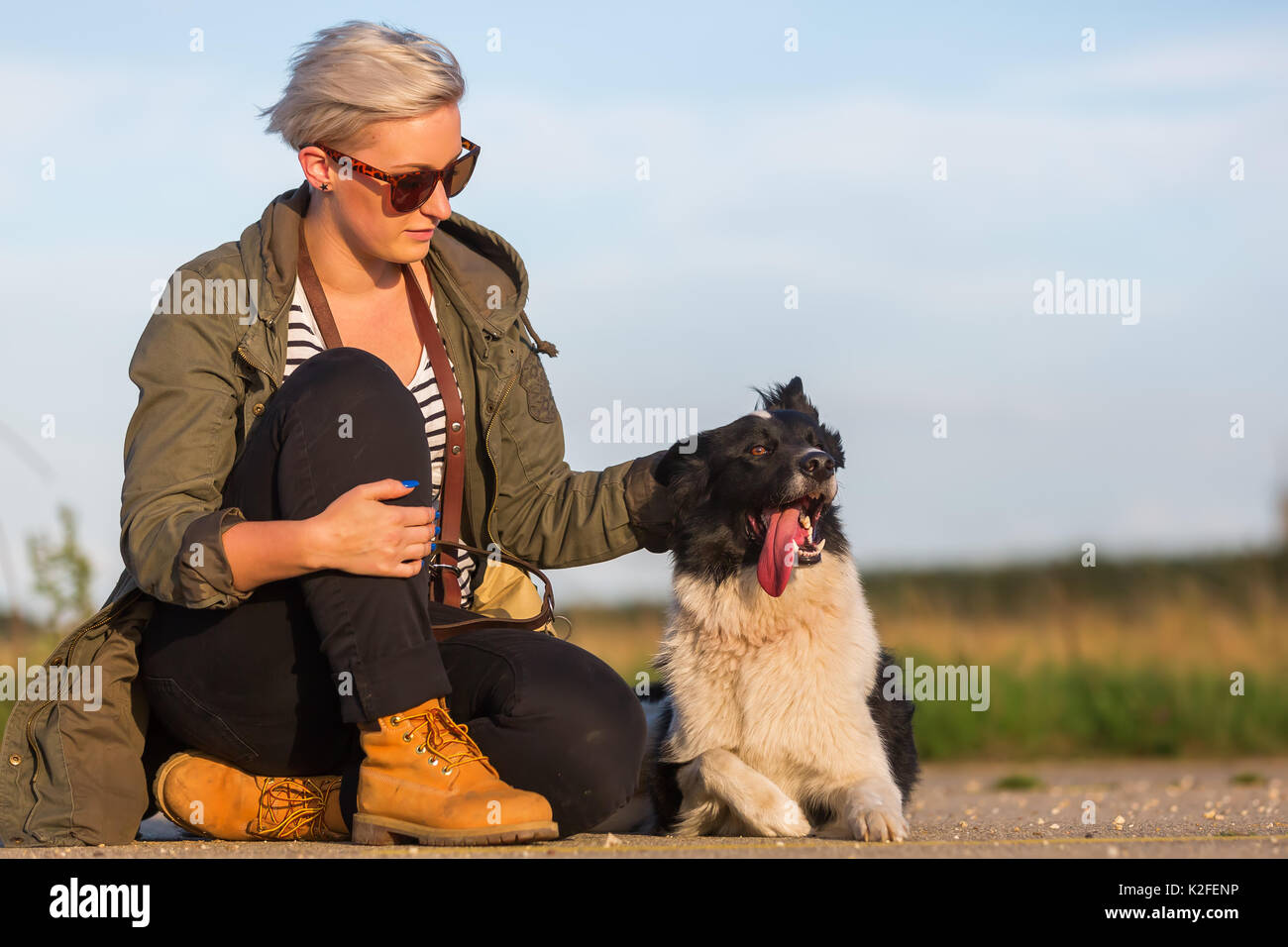 Woman sitting border collie on hi-res stock photography and images - Alamy