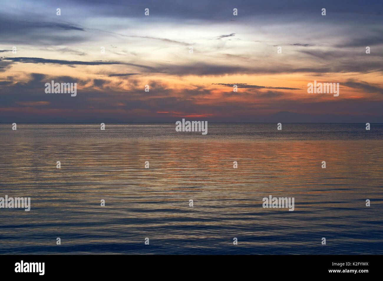 Sunset over water Stock Photo - Alamy