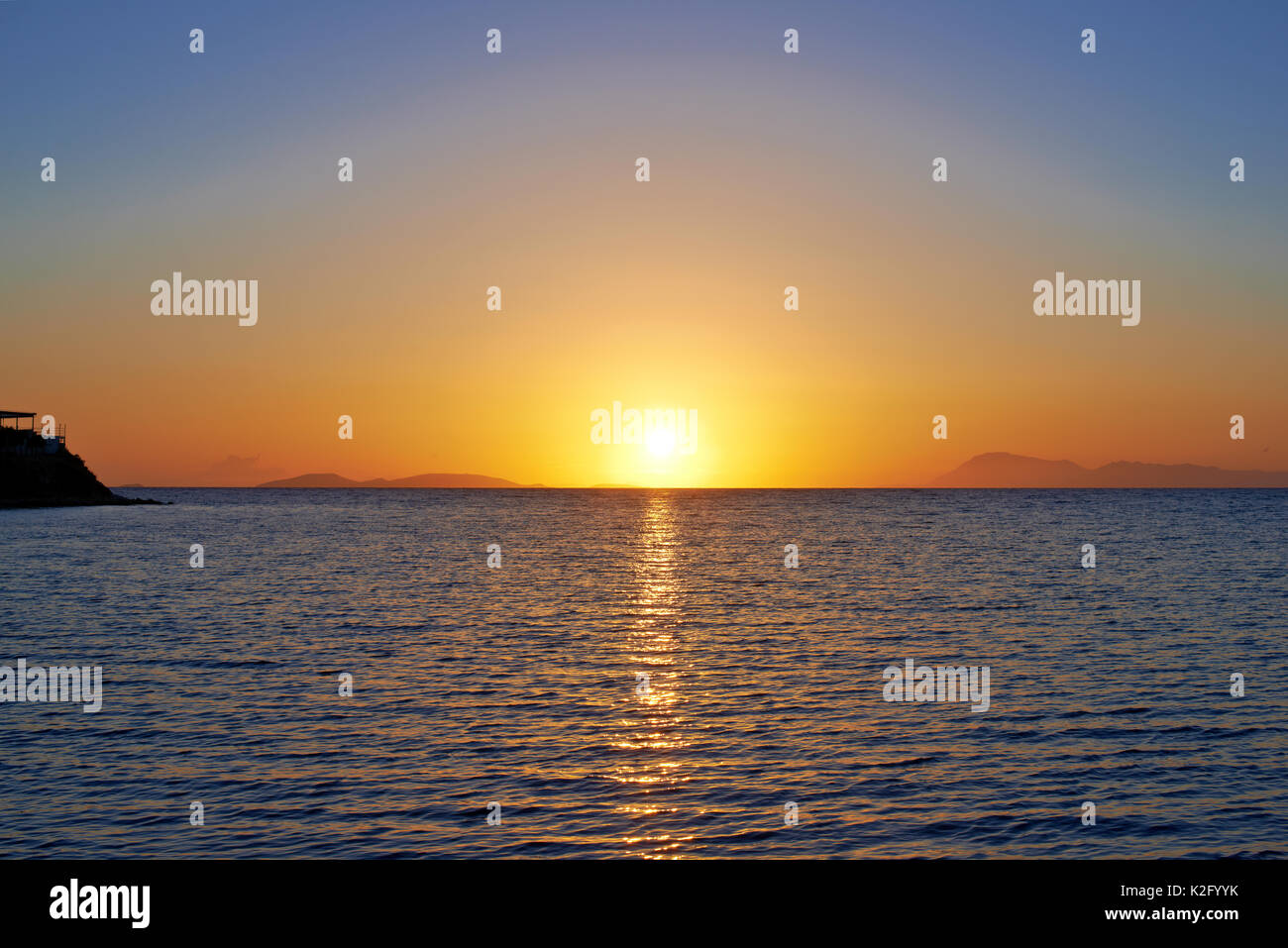 Sunset over water Stock Photo - Alamy