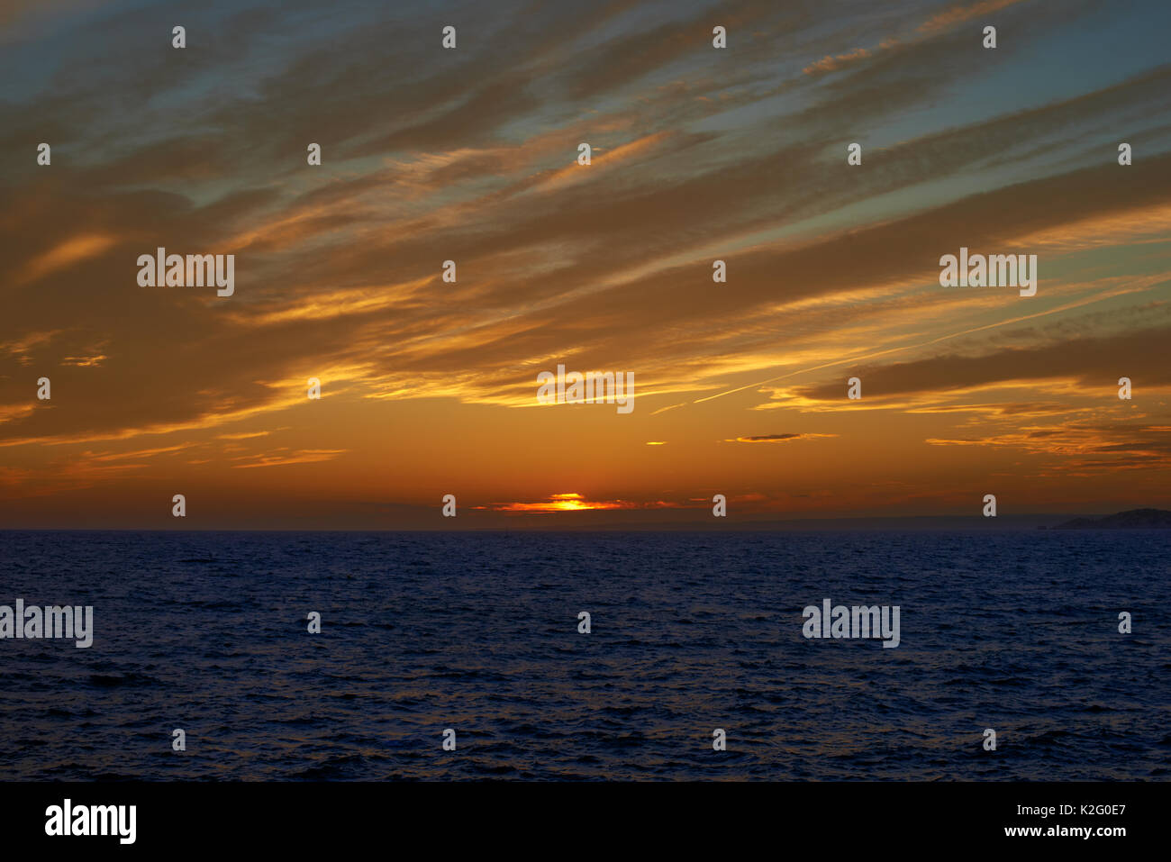Sunset over water Stock Photo - Alamy