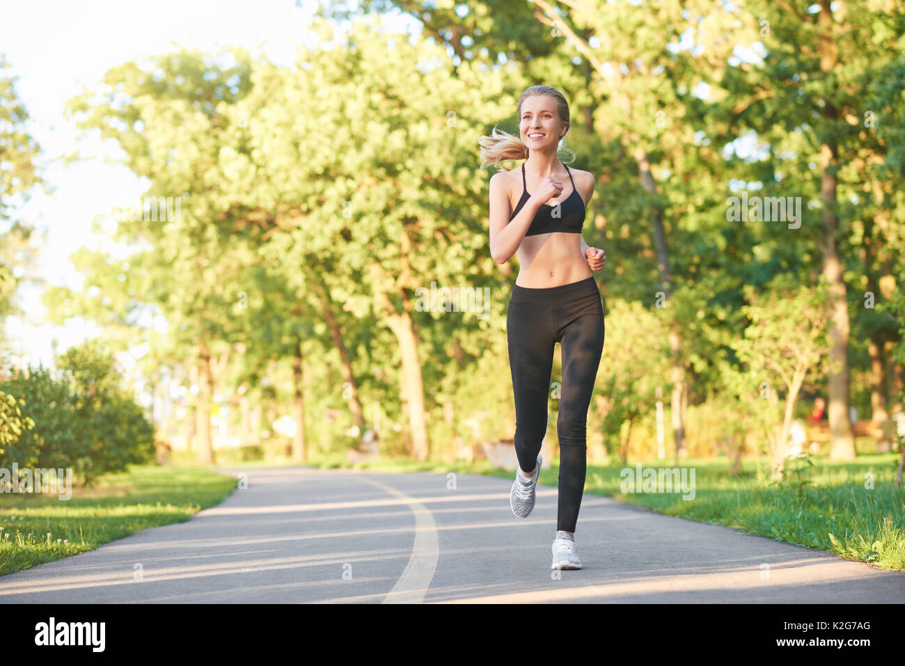 Female runner jogging in the forest Stock Photo - Alamy