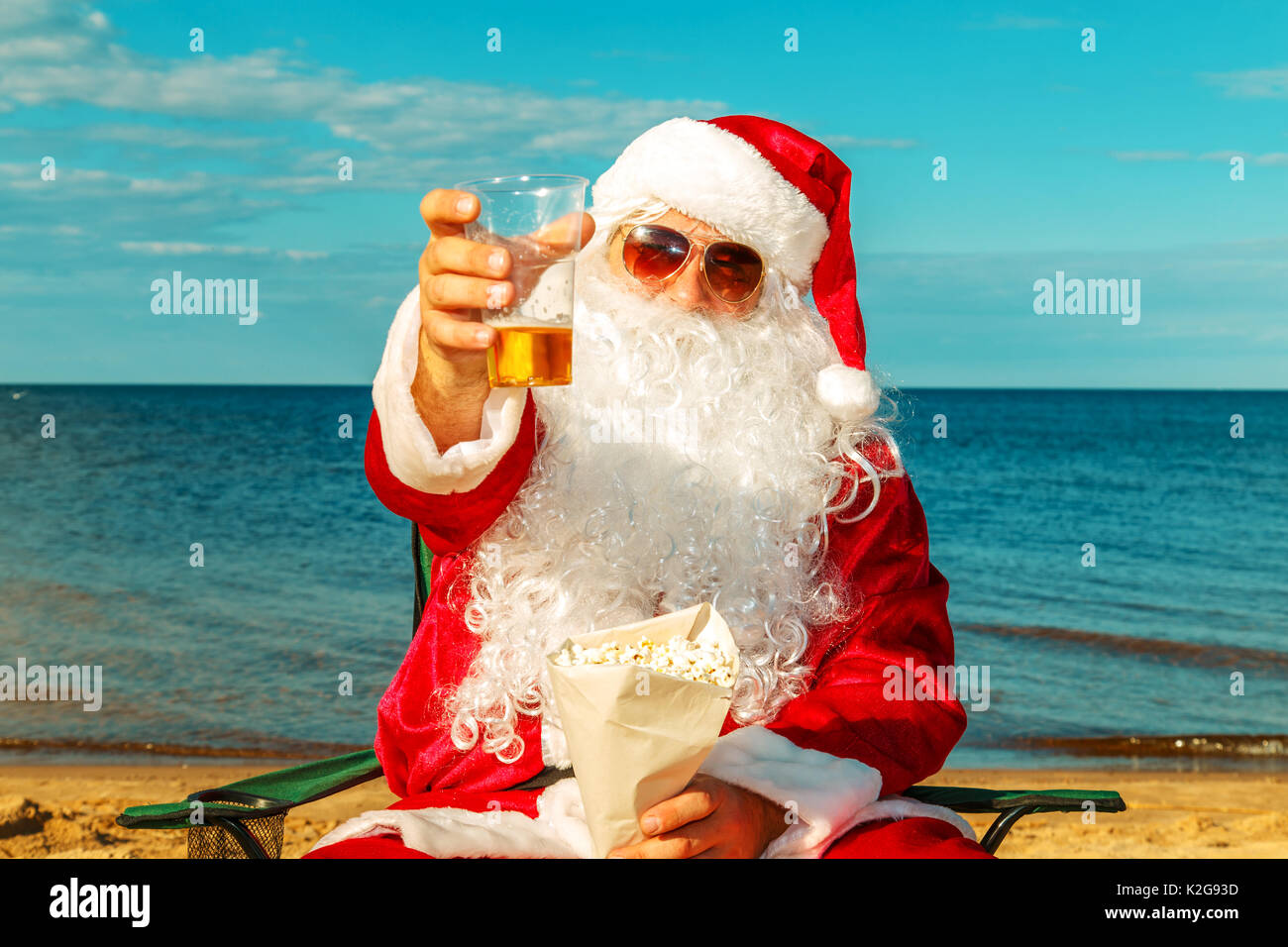 Santa Claus is resting on the beach with beer Stock Photo - Alamy