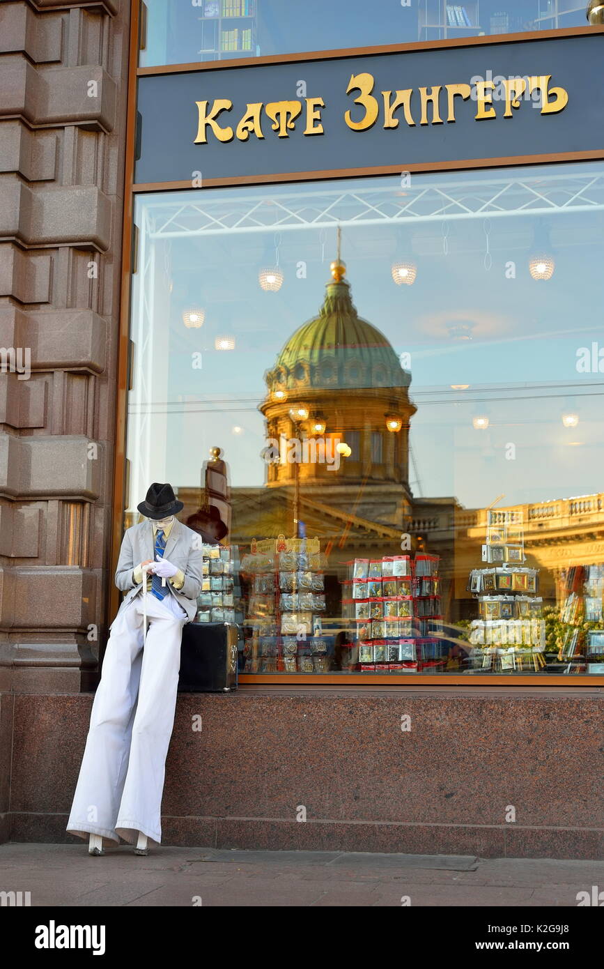 Clown-MIME on stilts sits on the window of the Café singer in the ...