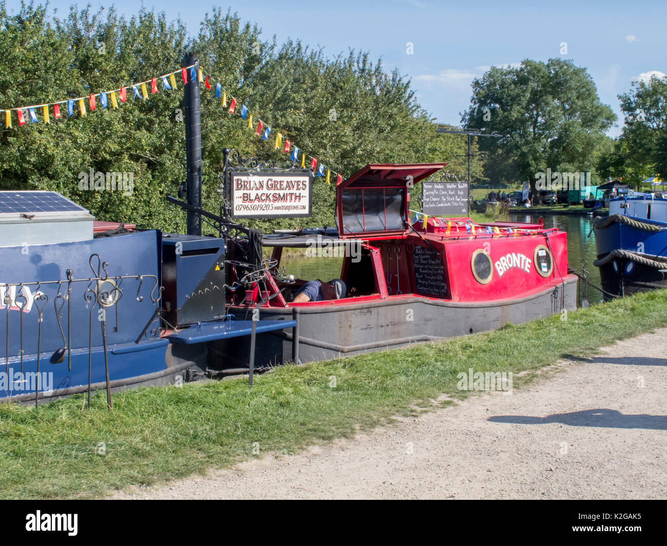 Blacksmith working his forge installed in a long boat, on the Grand ...