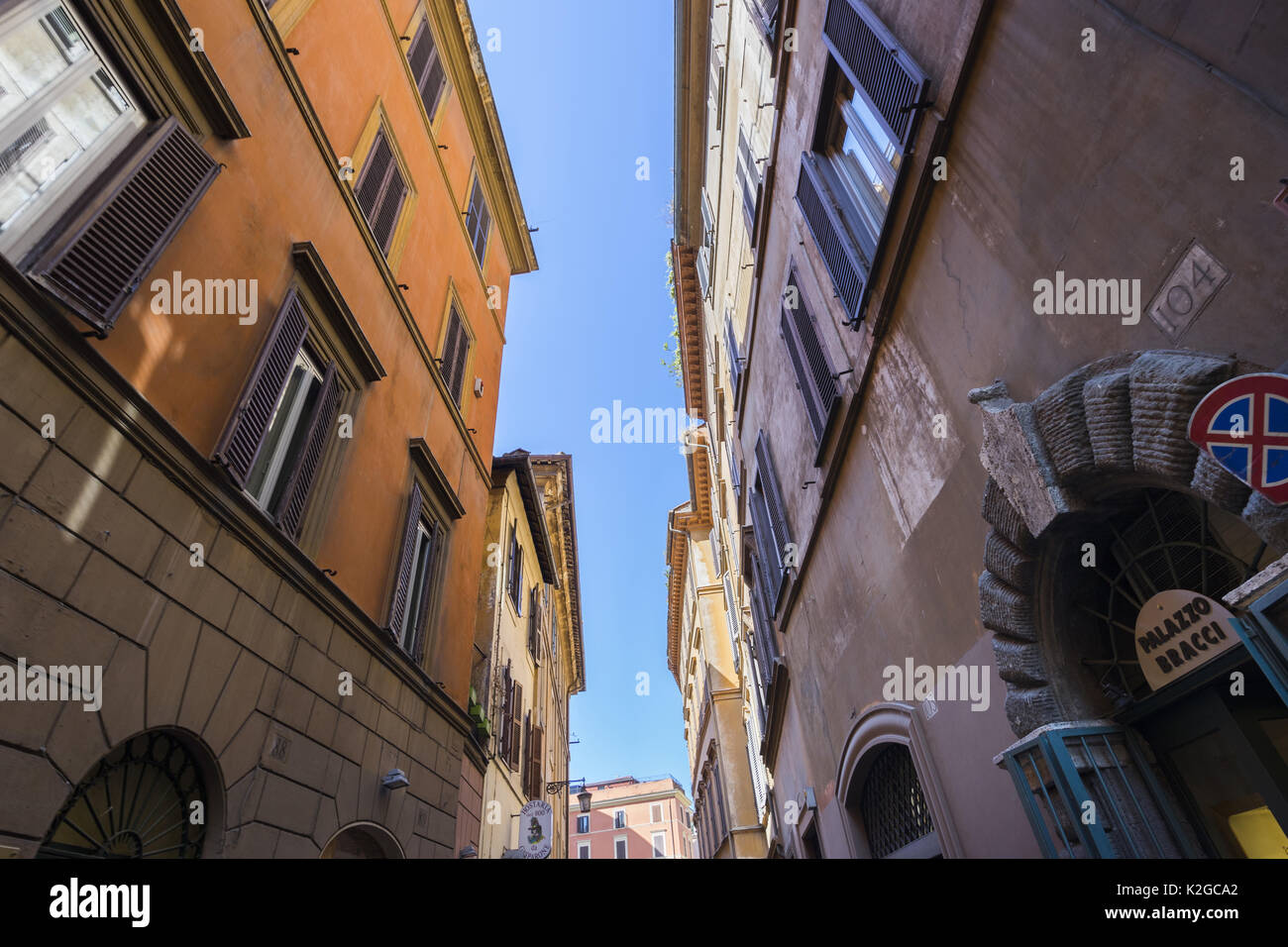 Tourists are walking around an old cozy street in Rome, Italy ...