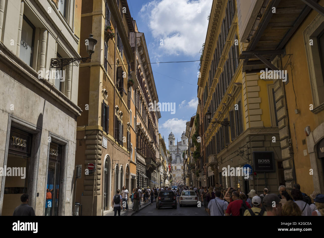 Tourists are walking around an old cozy street in Rome, Italy ...