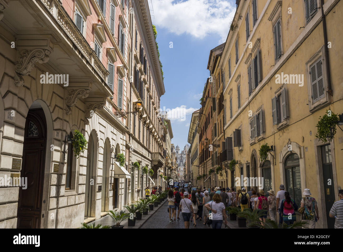 Tourists are walking around an old cozy street in Rome, Italy. Postcard ...