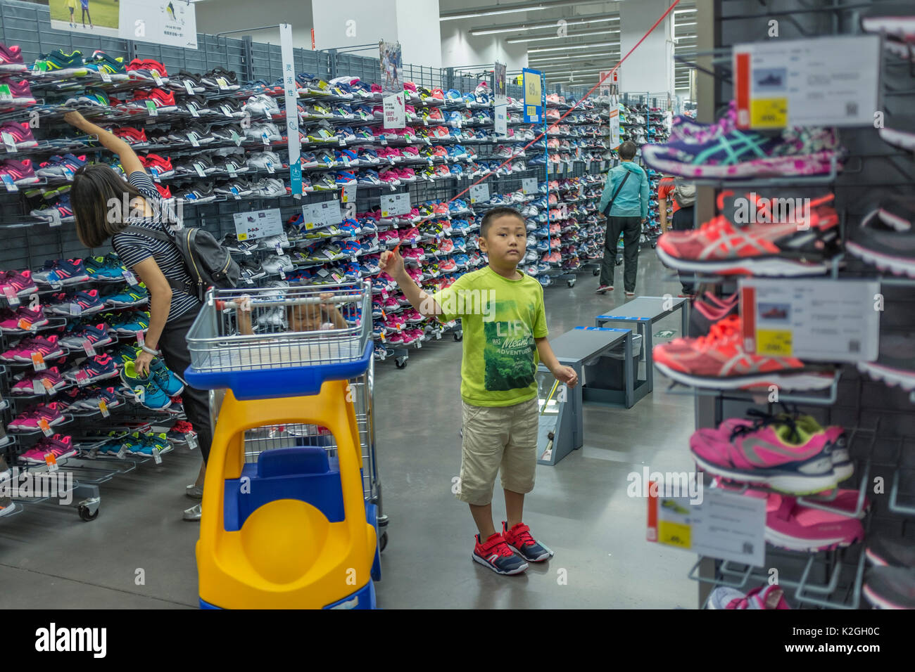 Customers buying walking shoes at a Carrefour store in Beijing, China ...
