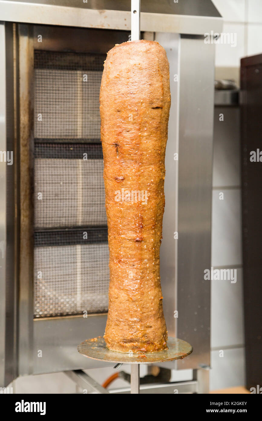Turkish grilled traditional dish Doner Kebab on a metal turning roast ...