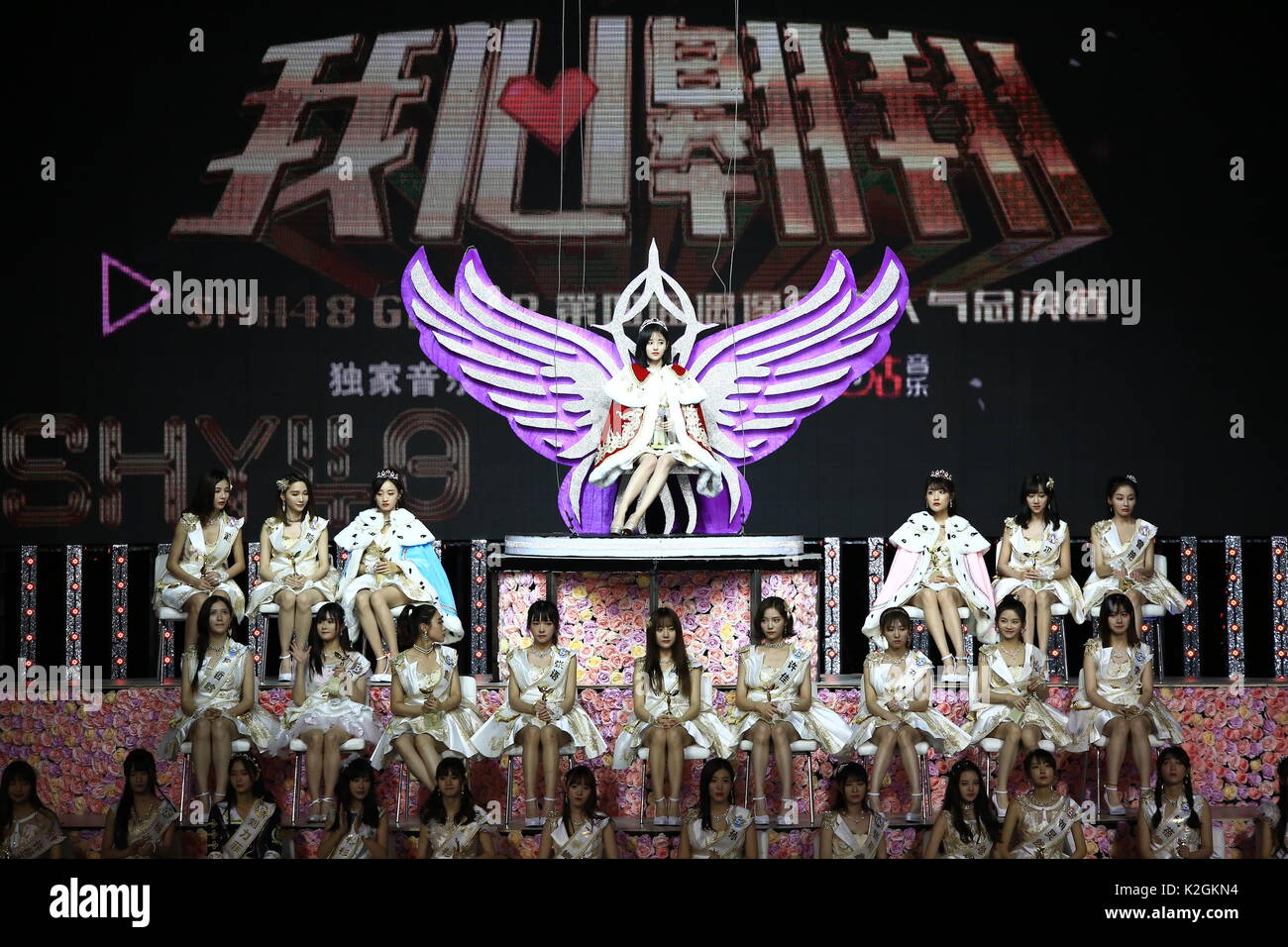 Winner Ju Jingyi, back center, of Chinese girl group SNH48 sits on the ...