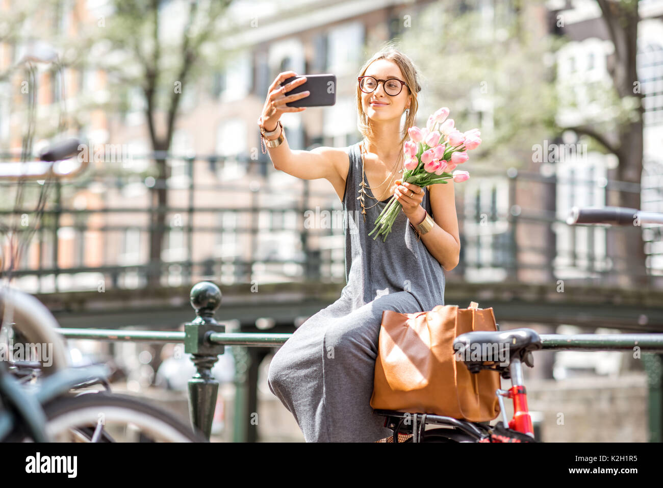 Woman with flowers in Amsterdam city Stock Photo - Alamy