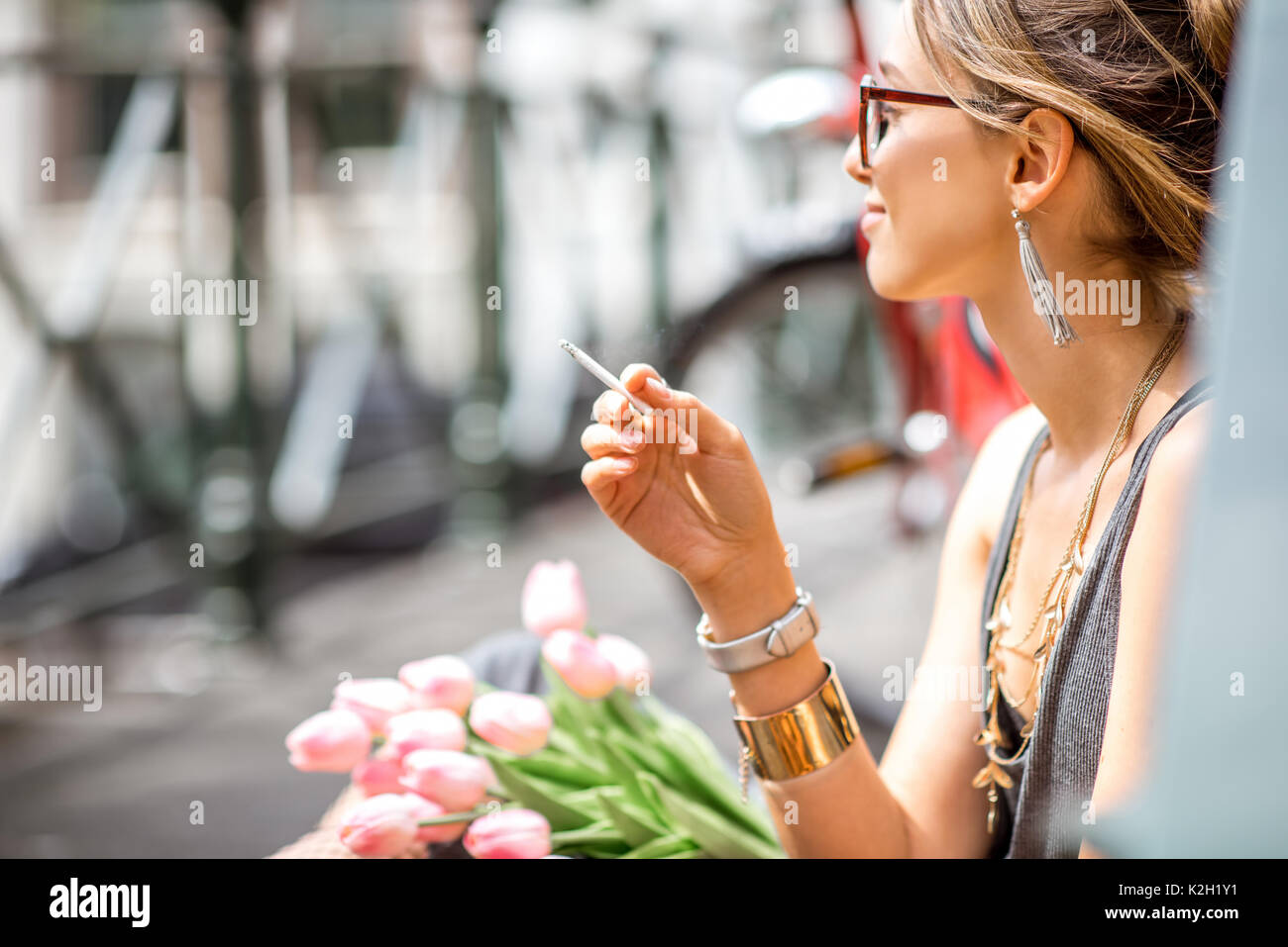 Woman smoking in Amsterdam city Stock Photo - Alamy