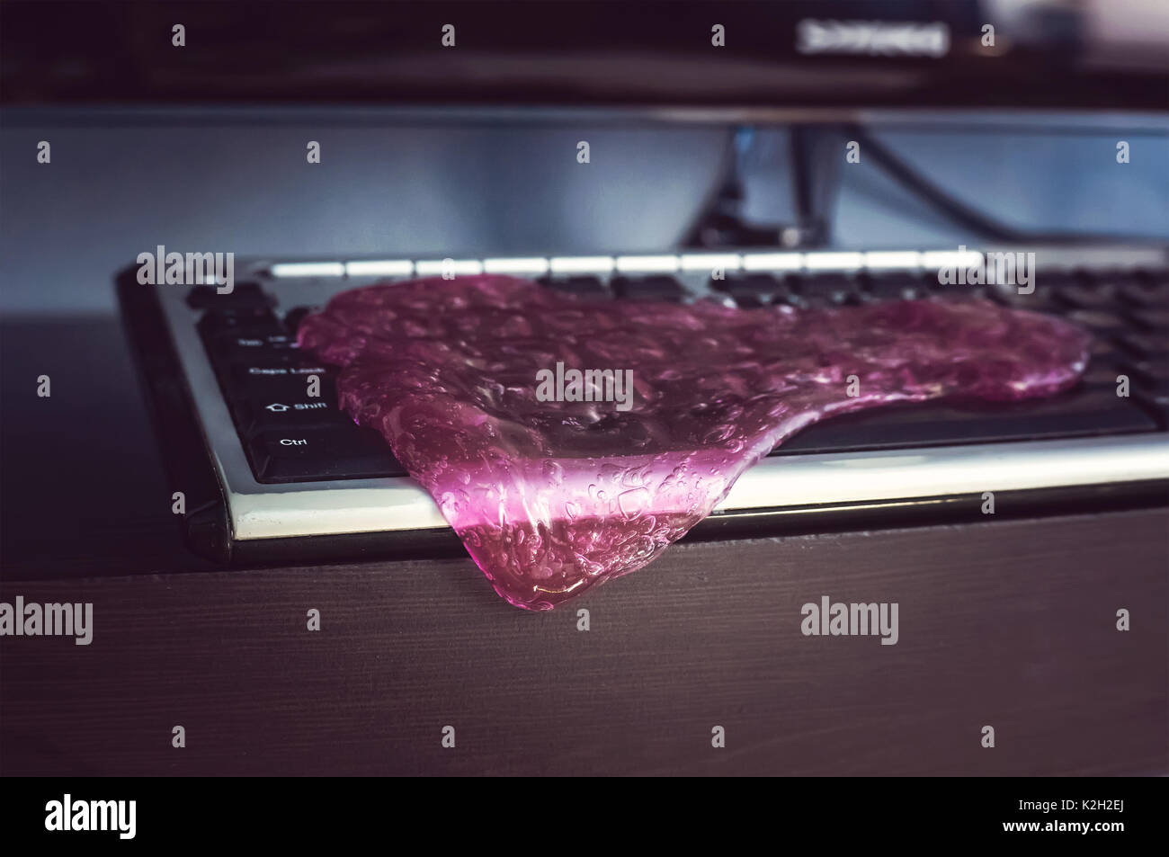 Keyboard cleaning gel is laying on the notebook. pink gel Stock Photo ...