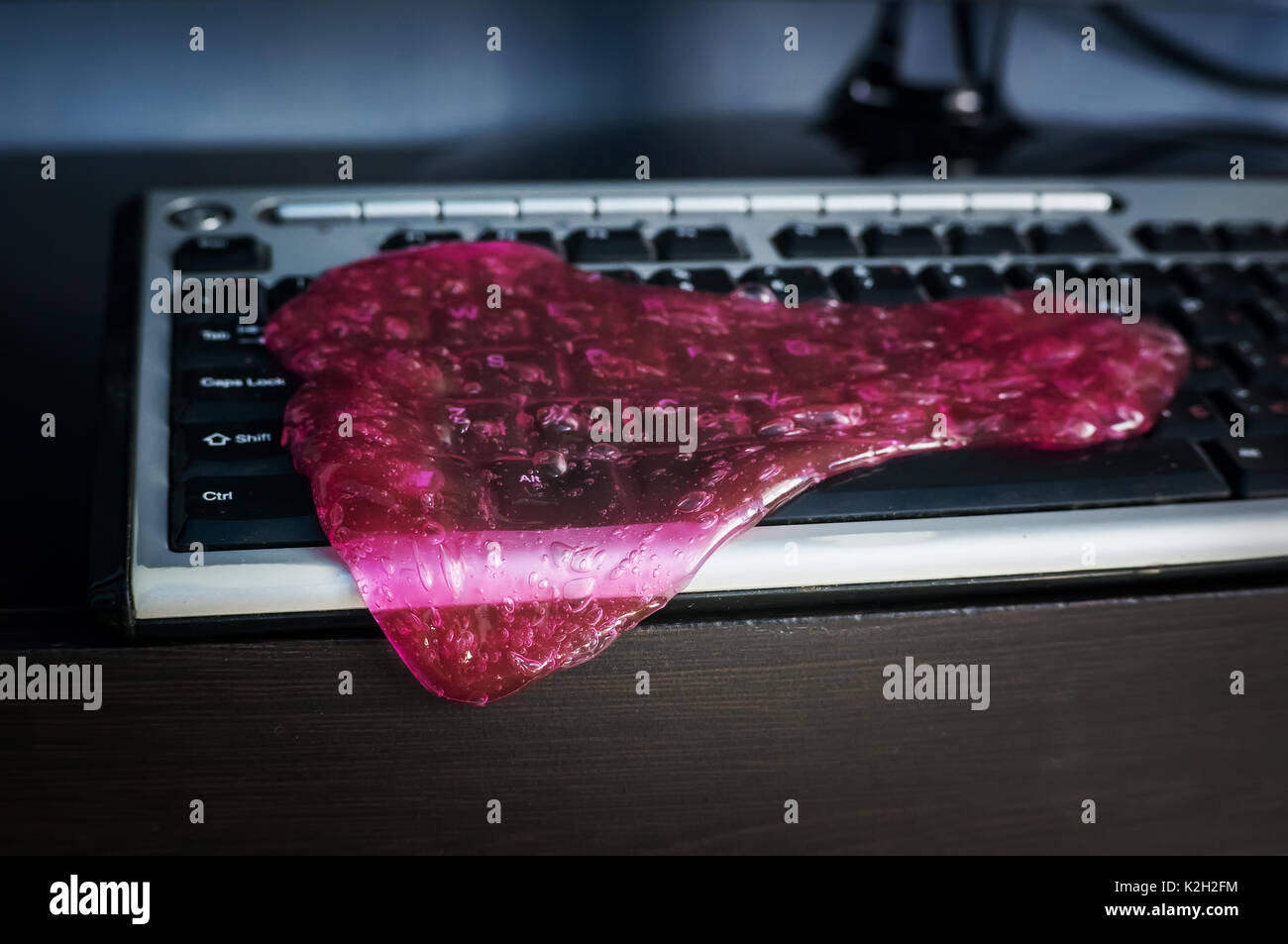 The red slime spread on the computer keyboard. Tools for quick cleaning ...