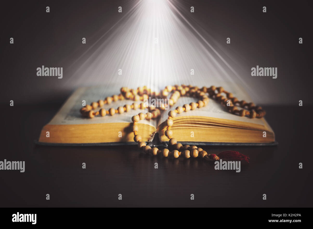 still life with books and rosary in the church. Holy book with the ...