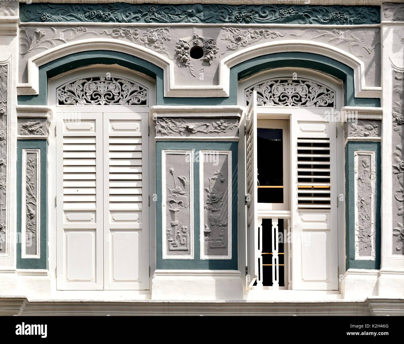 Traditional shop house exterior with white wooden louvered shutters ...