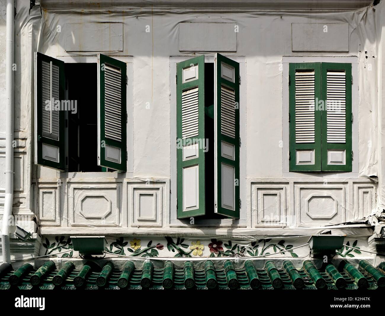 Traditional shop house exterior with green and white wooden louvered ...