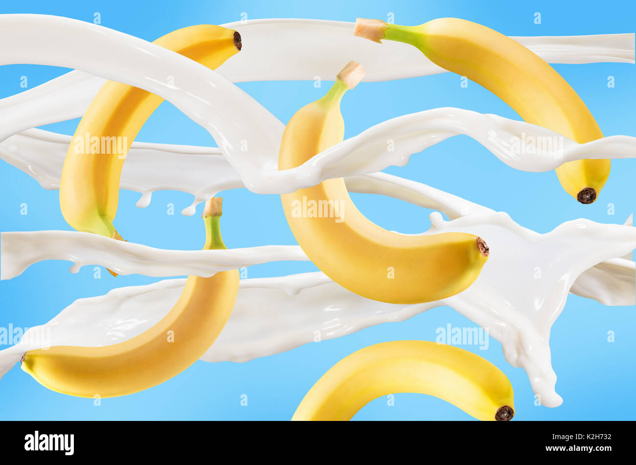 milk splash with Bananas on blue background Stock Photo - Alamy