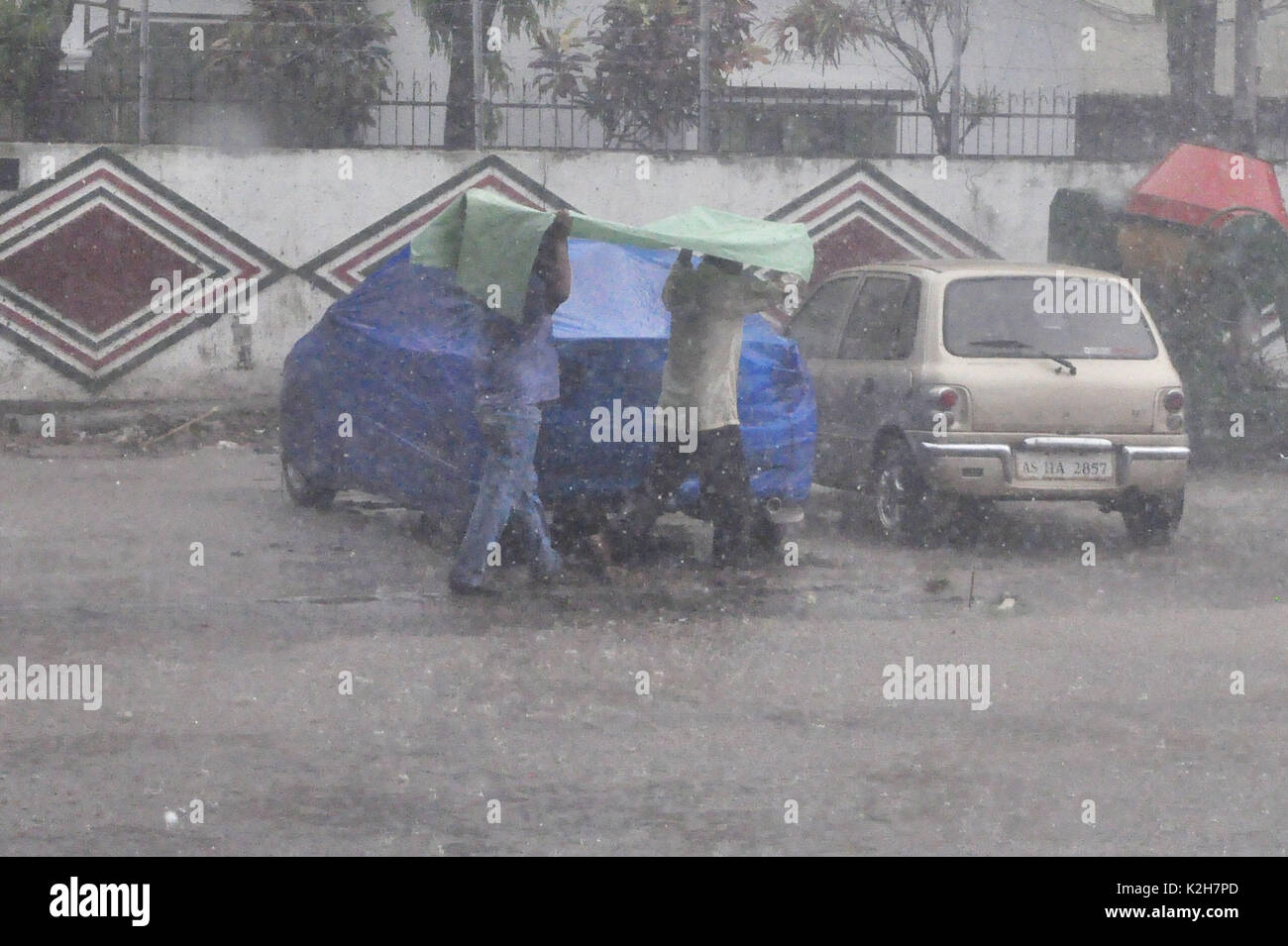 Agartala, India. 30th Aug, 2017. People are trying to take shelter in heavy rain at Agartala ...