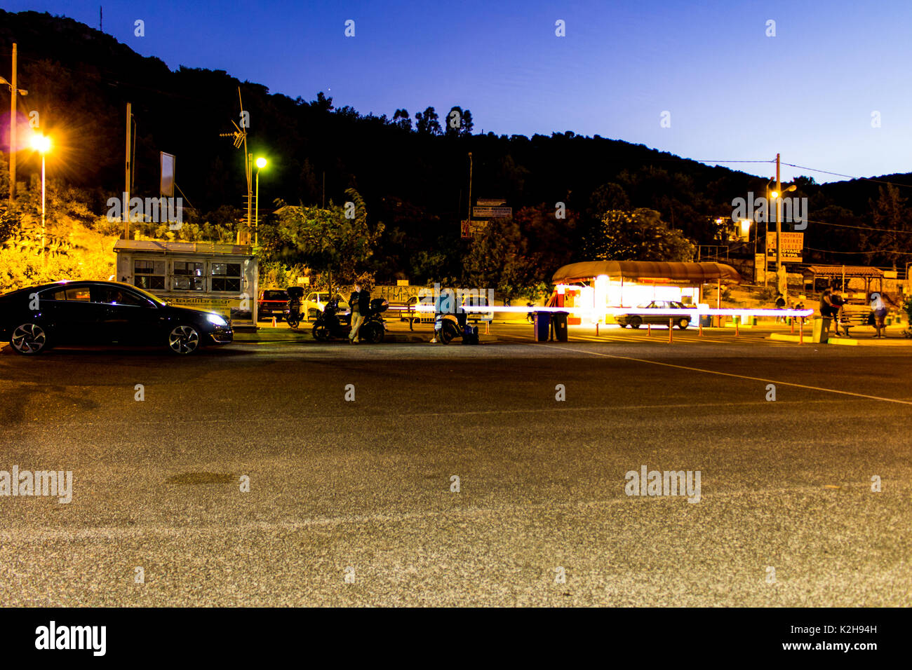 Cars waiting in line at the port of Agia Marina, Marathonas, Greece to ...