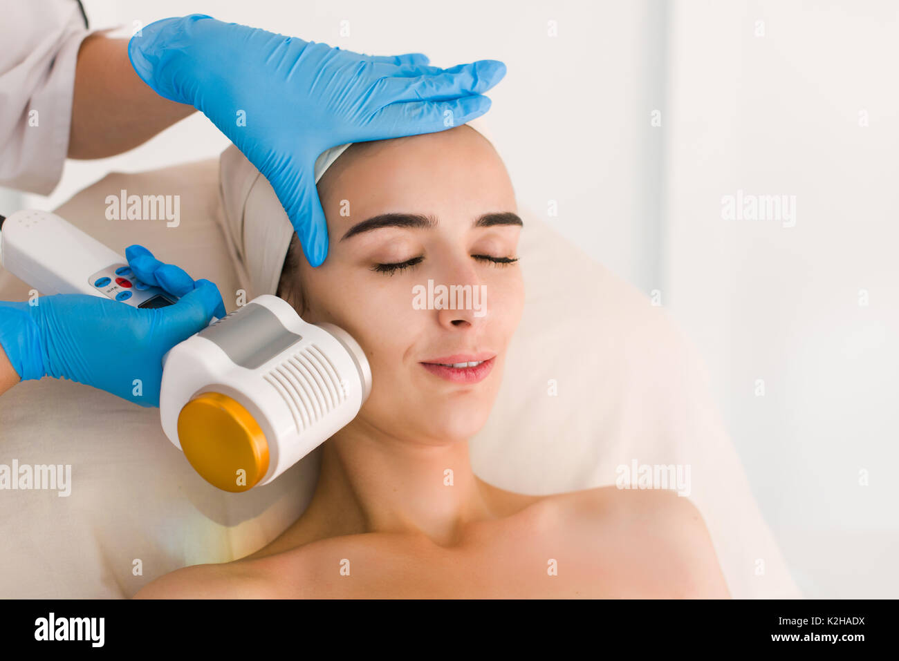 Skin care. Young woman receiving facial beauty treatment. Facial ...