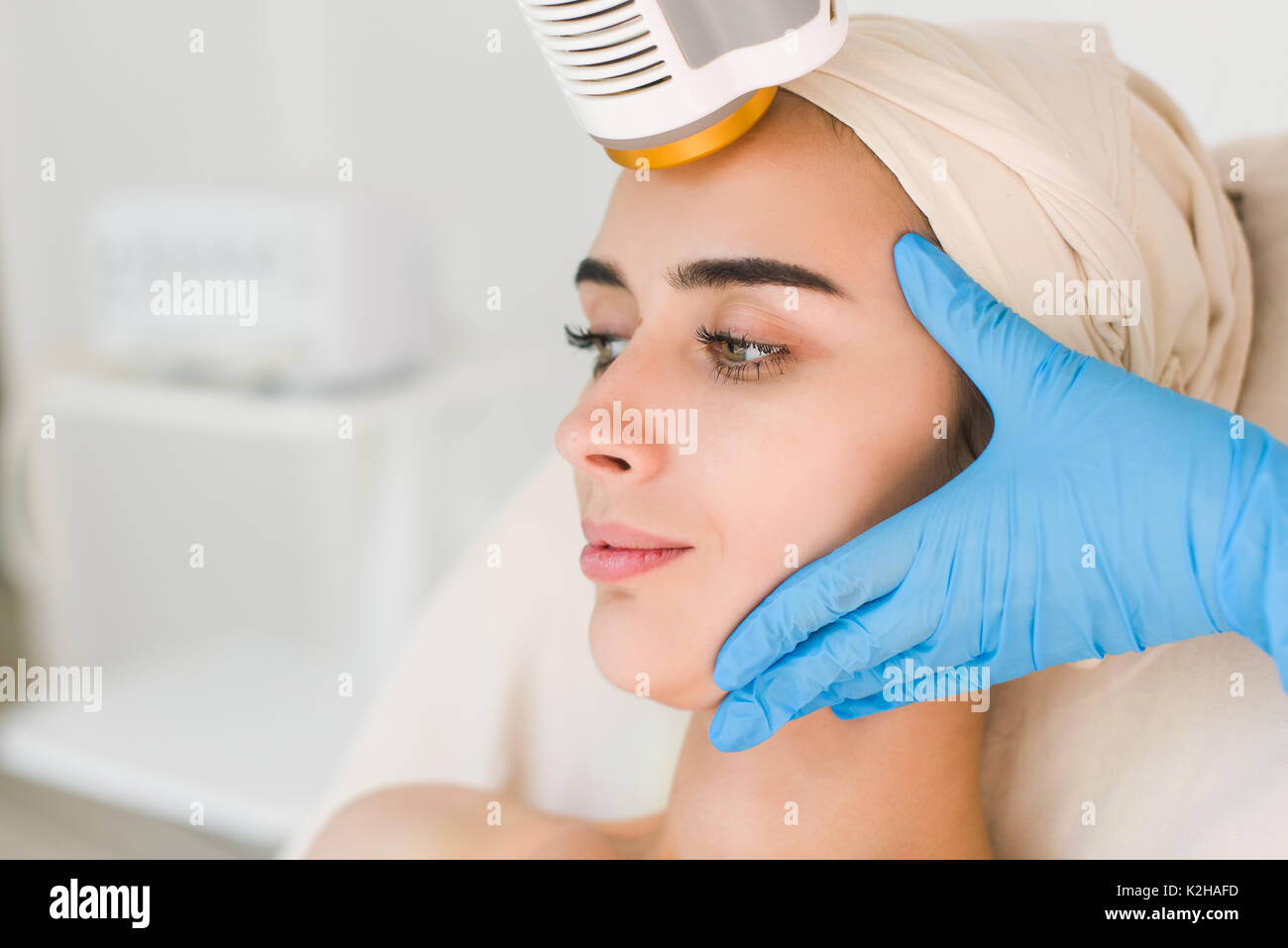 Young healthy woman with good skin doing cosmetic procedures in spa ...