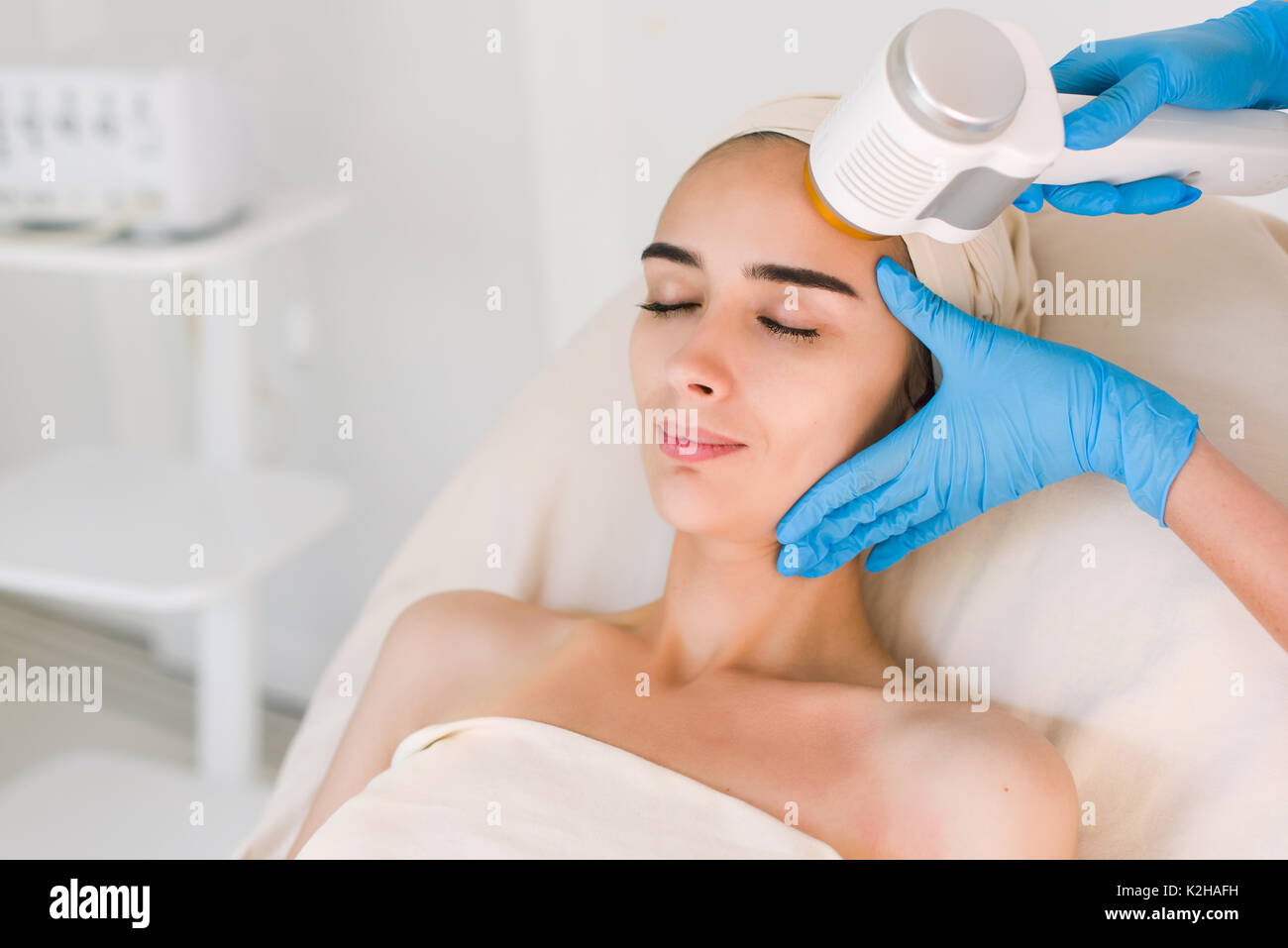 Young healthy woman with good skin doing cosmetic procedures in spa ...
