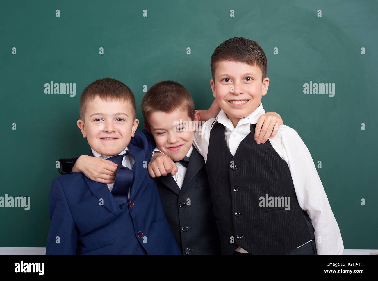 elementary school boy friends, fooling around near blank chalkboard ...
