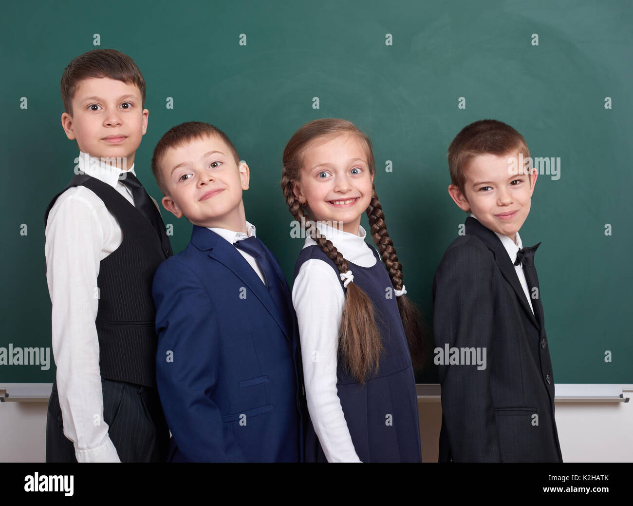 elementary school boy friends, fooling around near blank chalkboard ...