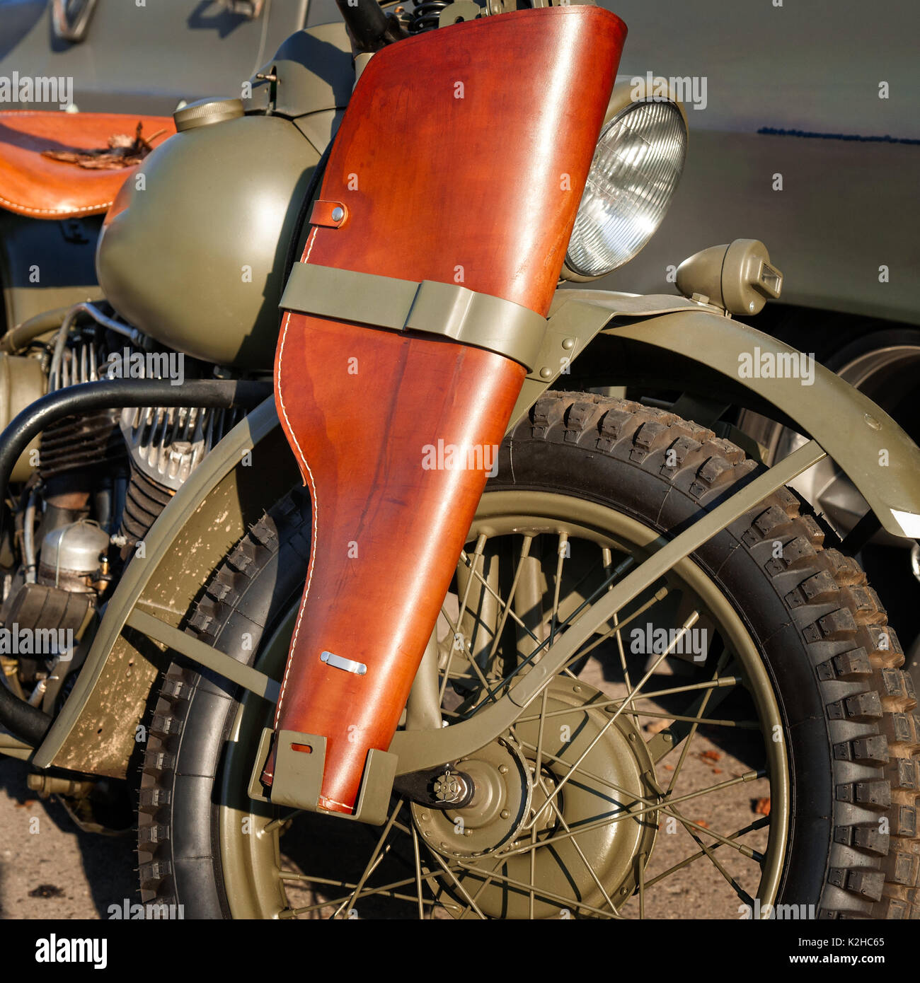 Closeup view of a military motorcycle with a leather rifle holster ...