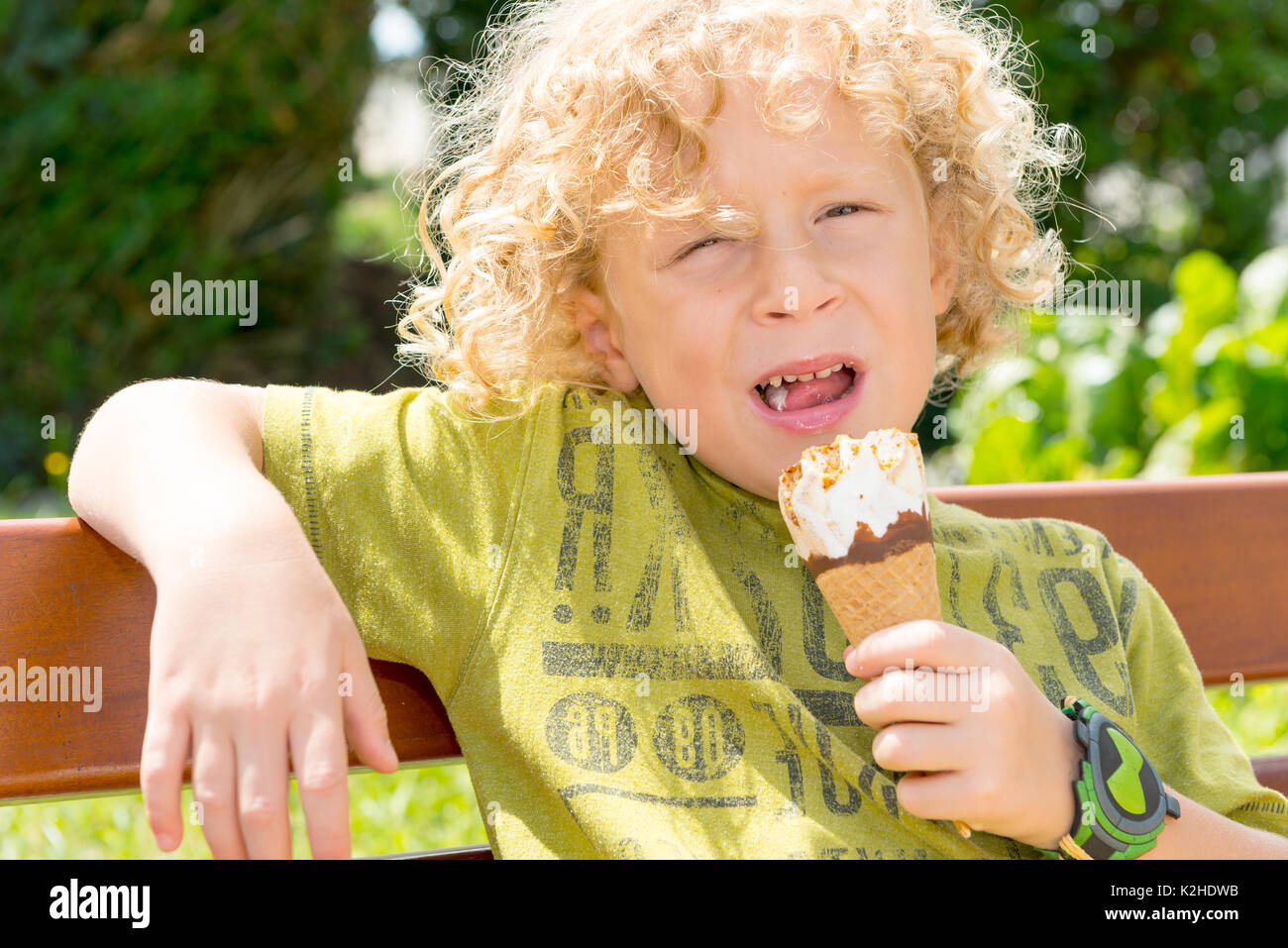 Cute blonde boy eating ice hi-res stock photography and images - Alamy