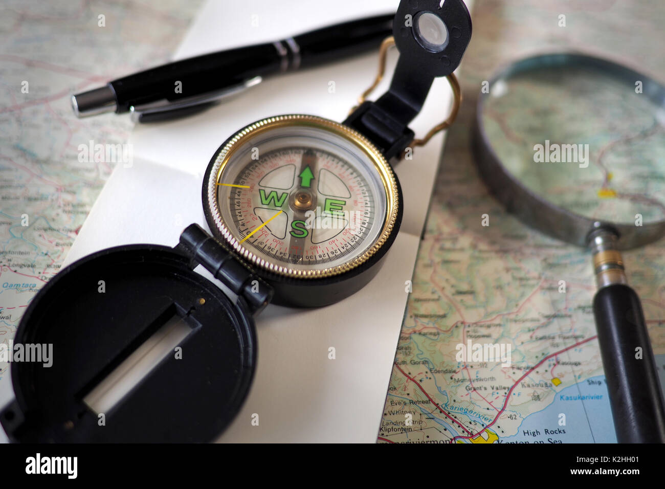 Compass, map and notebook for travel Stock Photo - Alamy