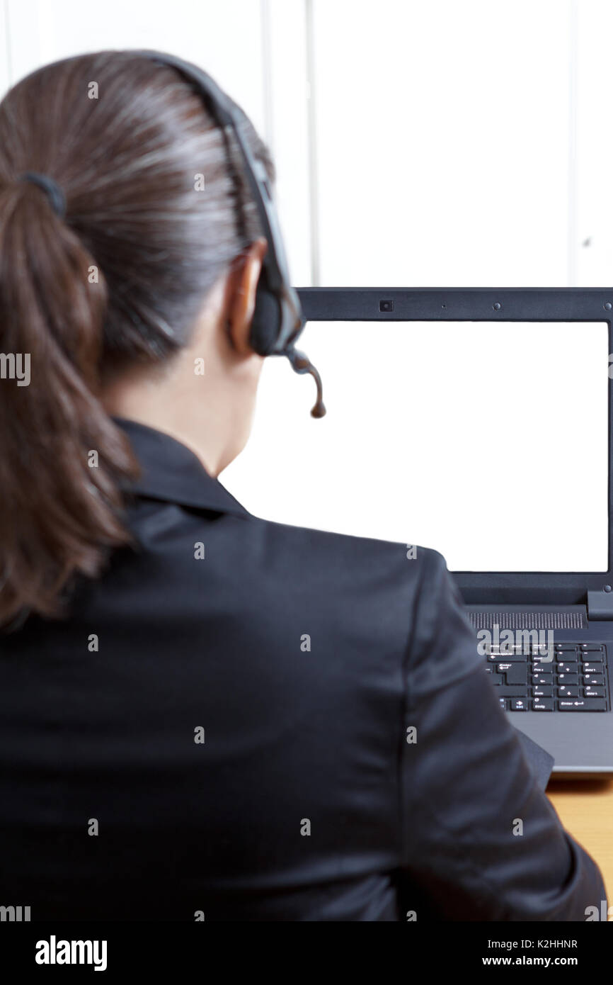 Rear view of a woman in a black blazer with headset and microphone in ...