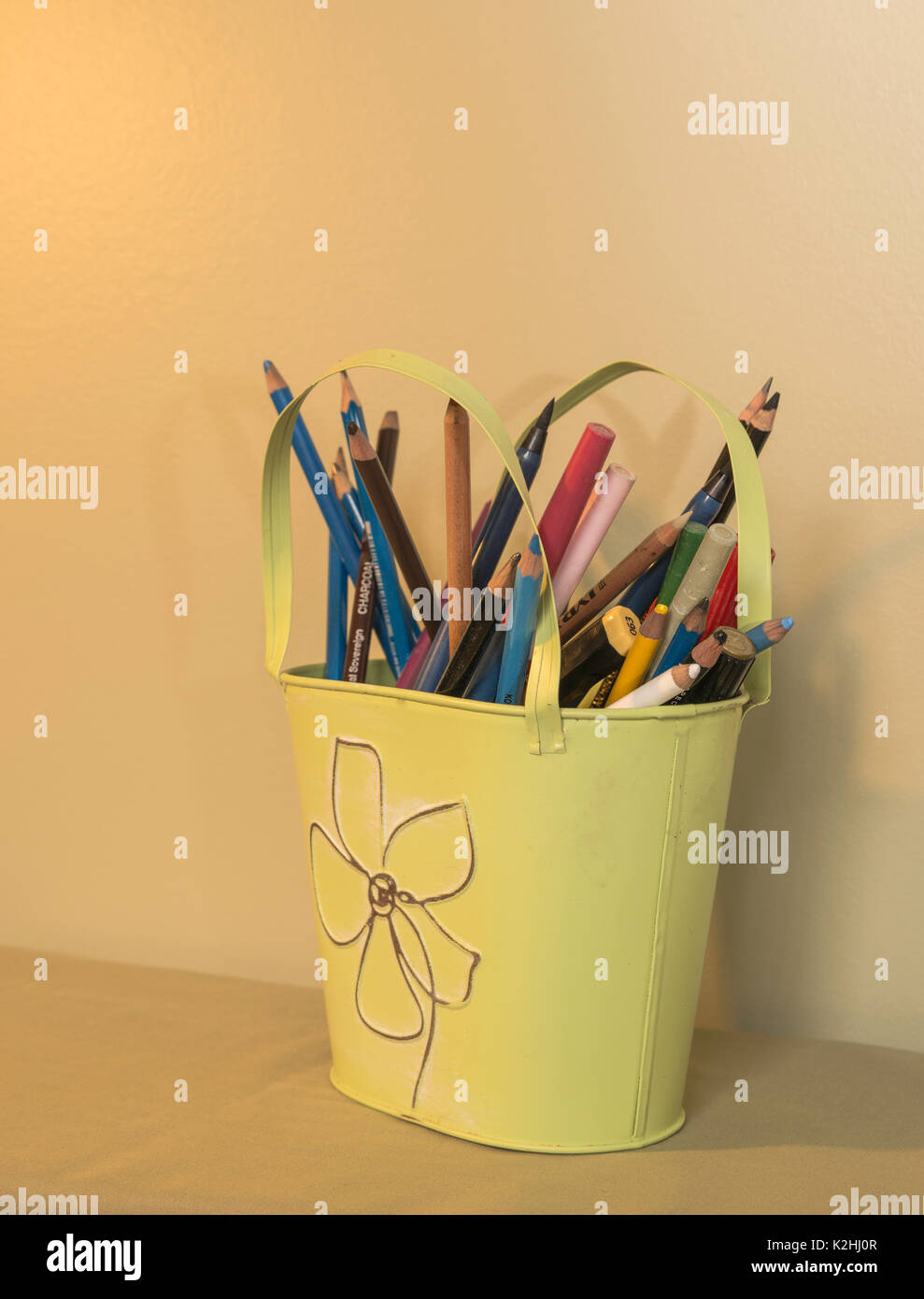 Decorative bucket holding art pencils, pens, and markers, copy space ...