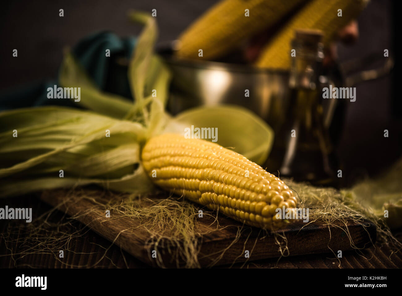 Whole corn on hob with husk, ready for cooking Stock Photo - Alamy