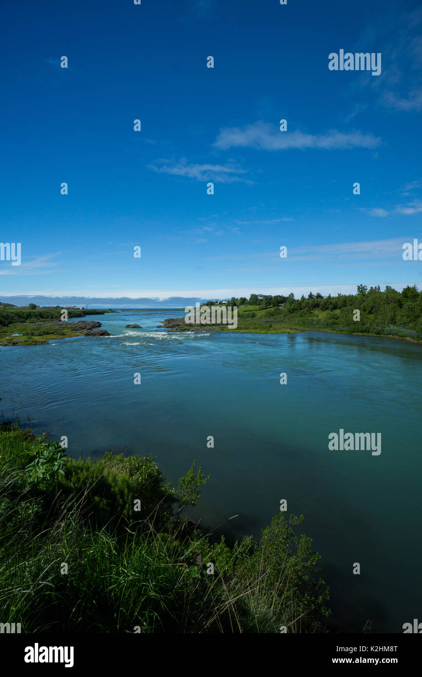 Iceland - Natural blue stream flowing into the ocean between green ...