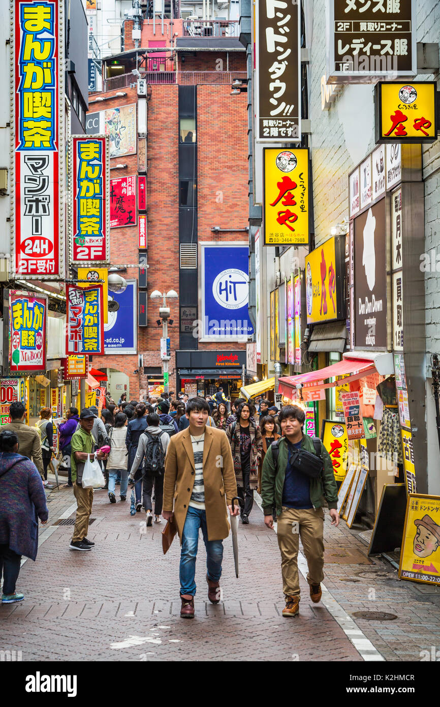 A shopping street with bright signs in the Shibuya district of Tokyo ...