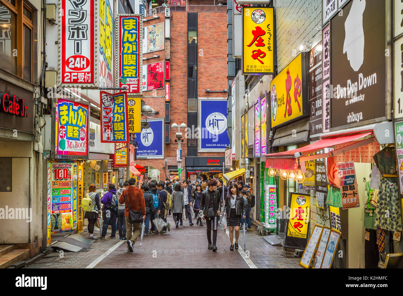 A shopping street with bright signs in the Shibuya district of Tokyo ...