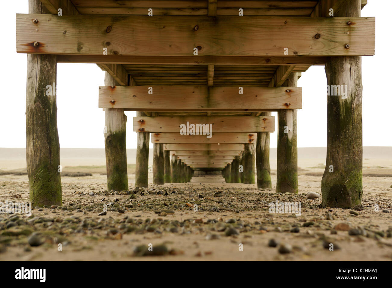 Underneath a wooden jetty at a shingle beach near Portland, UK Stock ...