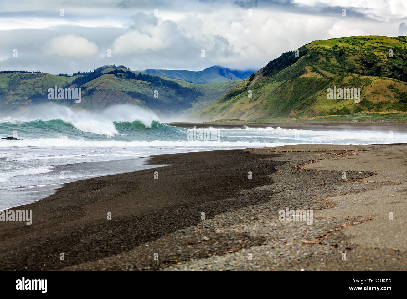 Wind whipped waves crash on the coast of California which stretches out ...