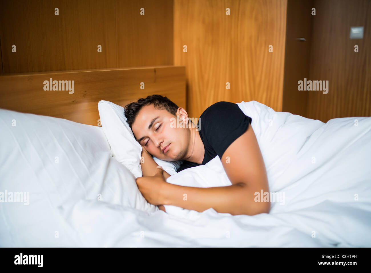 Man comfortably sleeping in his bed at night Stock Photo - Alamy