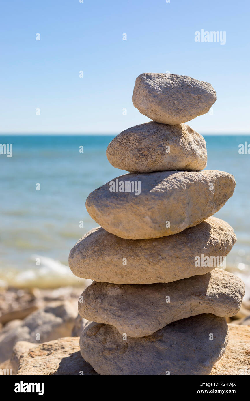 A balanced pile of stones in front of the waves from the ocean Stock ...