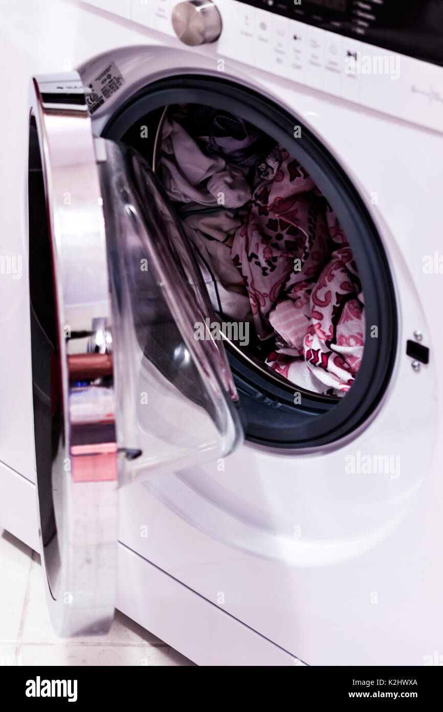 Washing machine full of clothes Stock Photo - Alamy