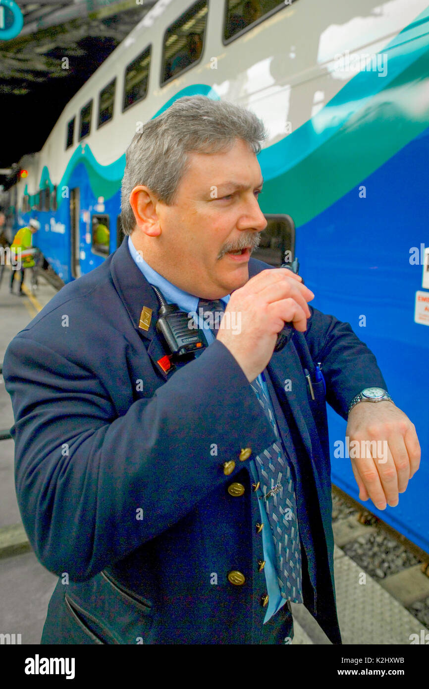 Having checked his watch, a railroad conductor in King Street Station ...