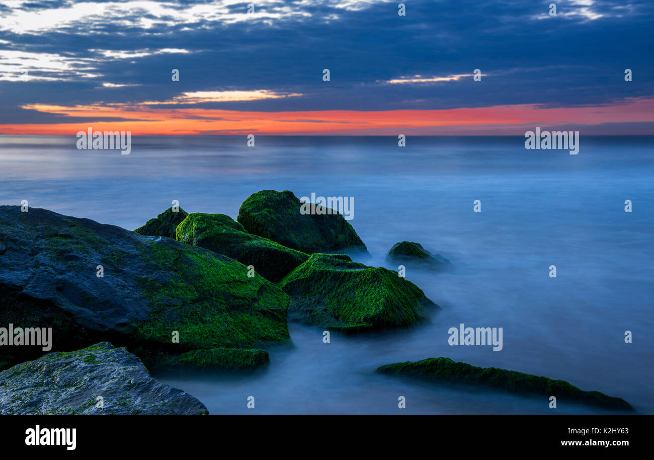Long exposure background during blue hour, showing water and stones on ...