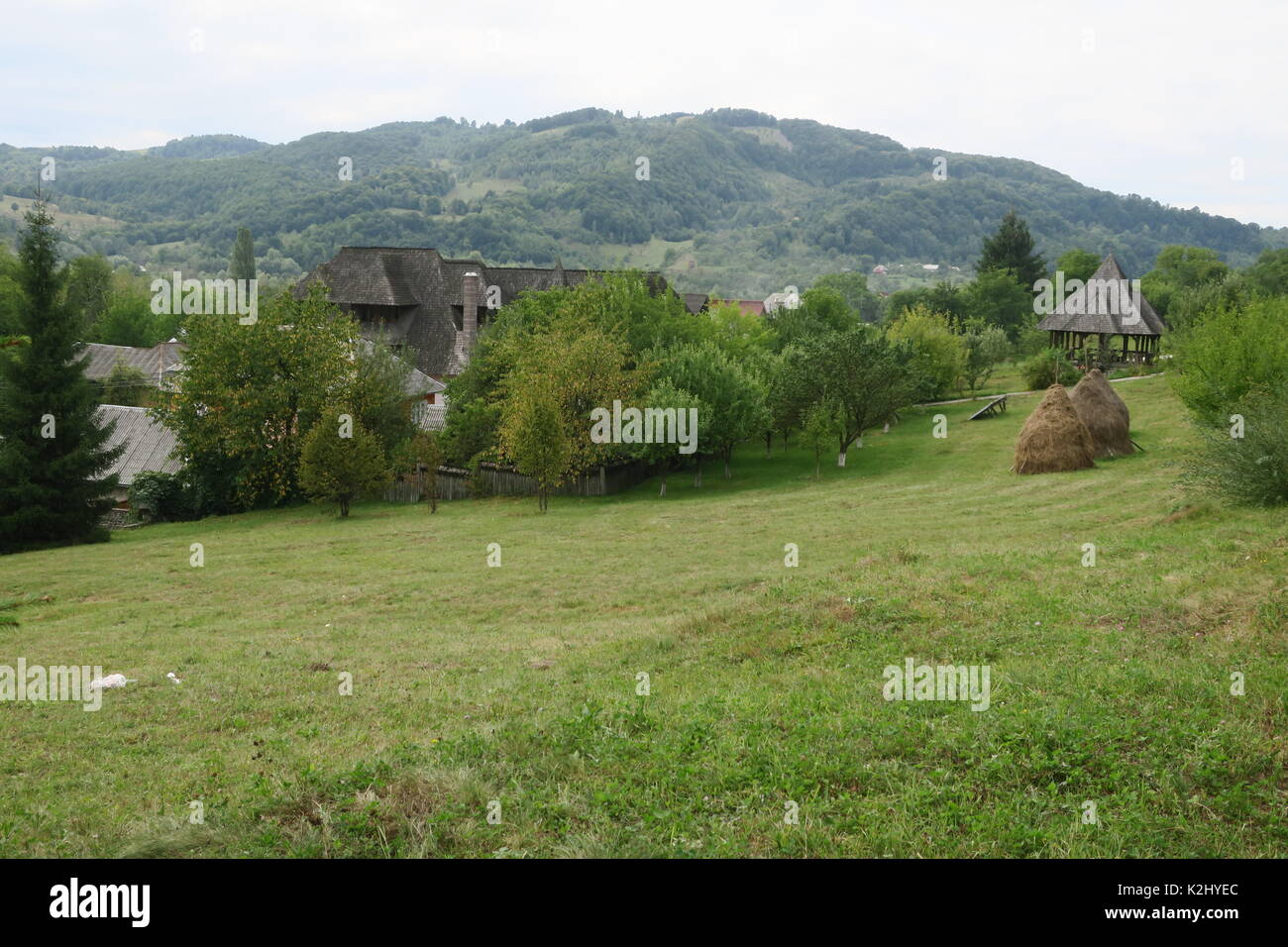 Traditional hay rick on a meadow near monastery complex in Barsana ...