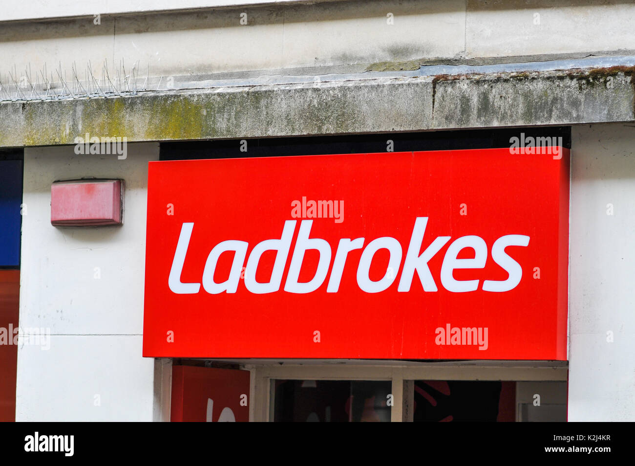 Ladbrokes betting shop sign England UK Stock Photo - Alamy